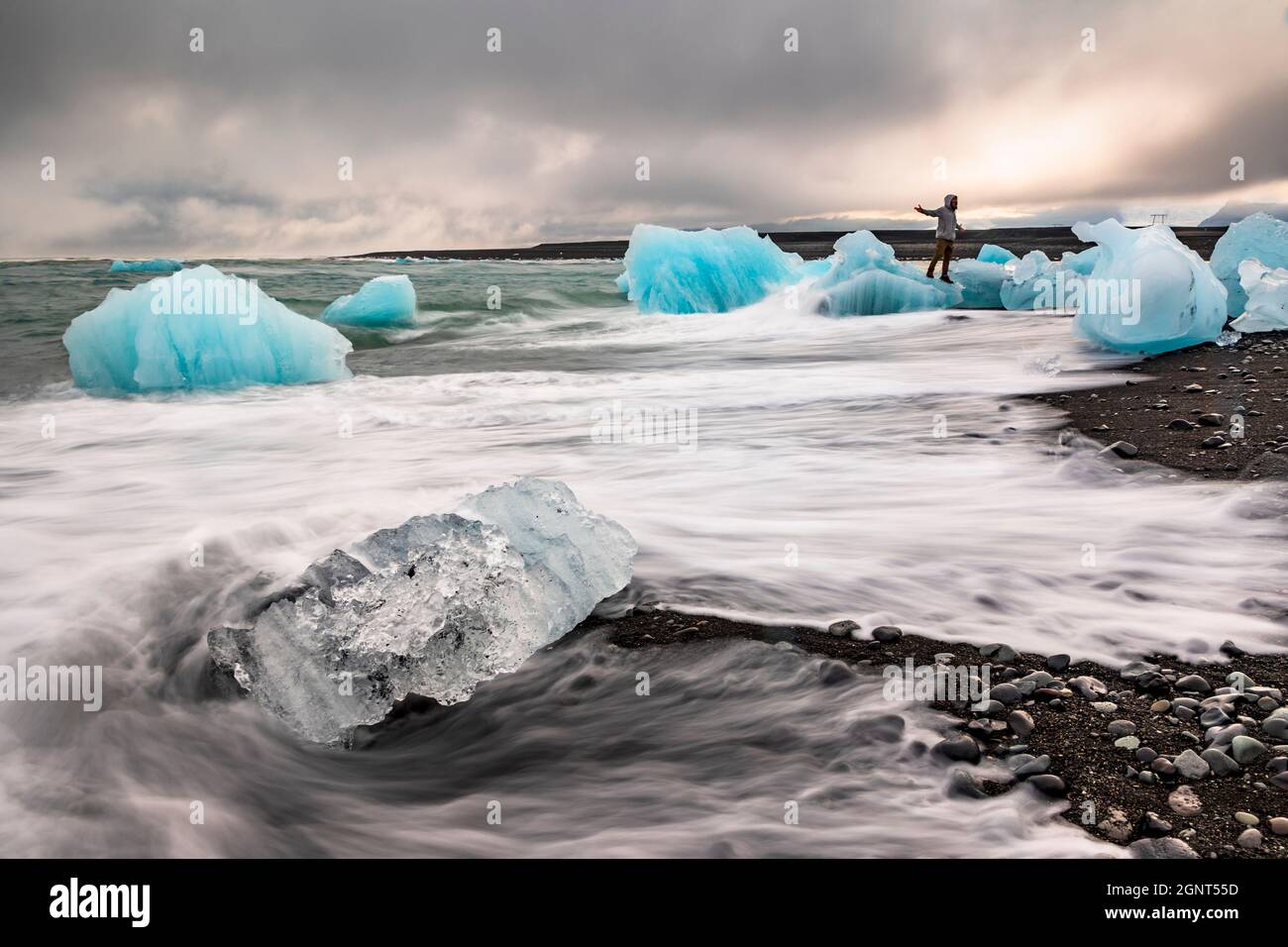 amazing blue colored icebergs washed ashore the black sand beach ...