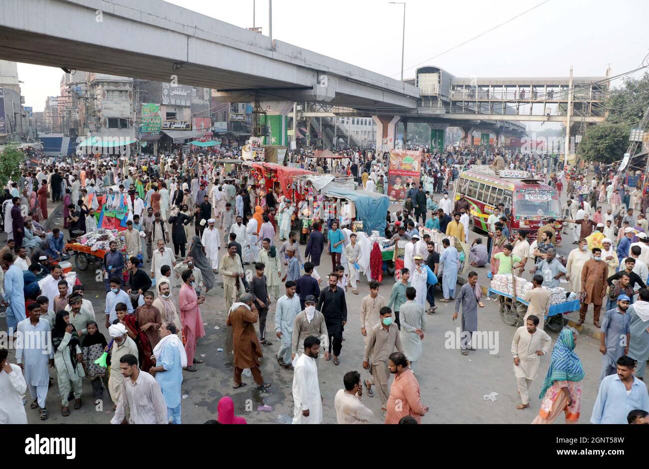 A large number of people gather outside at the shrine of Data Ganj ...