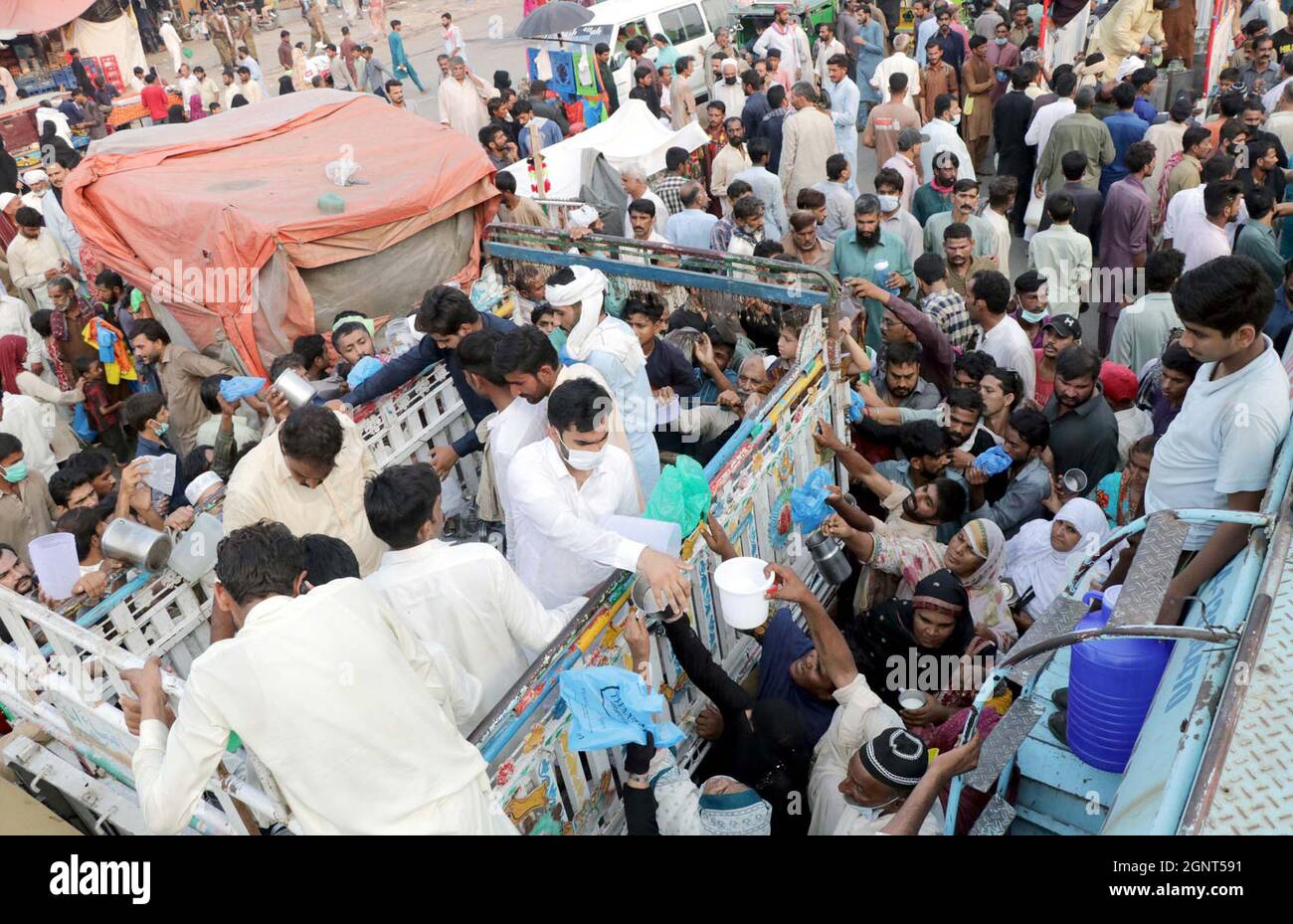 A large number of people gather outside at the shrine of Data Ganj ...