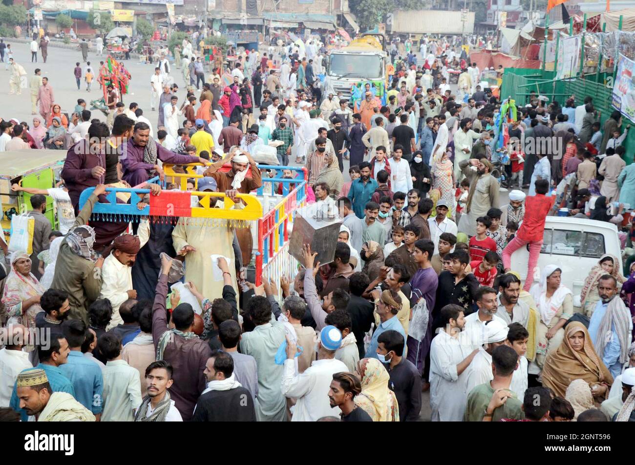 A large number of people gather outside at the shrine of Data Ganj ...