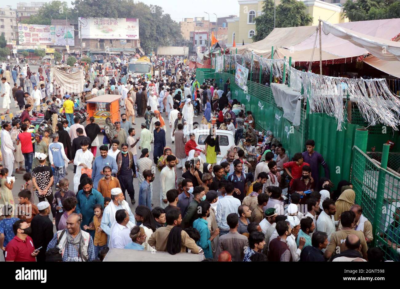 A large number of people gather outside at the shrine of Data Ganj ...