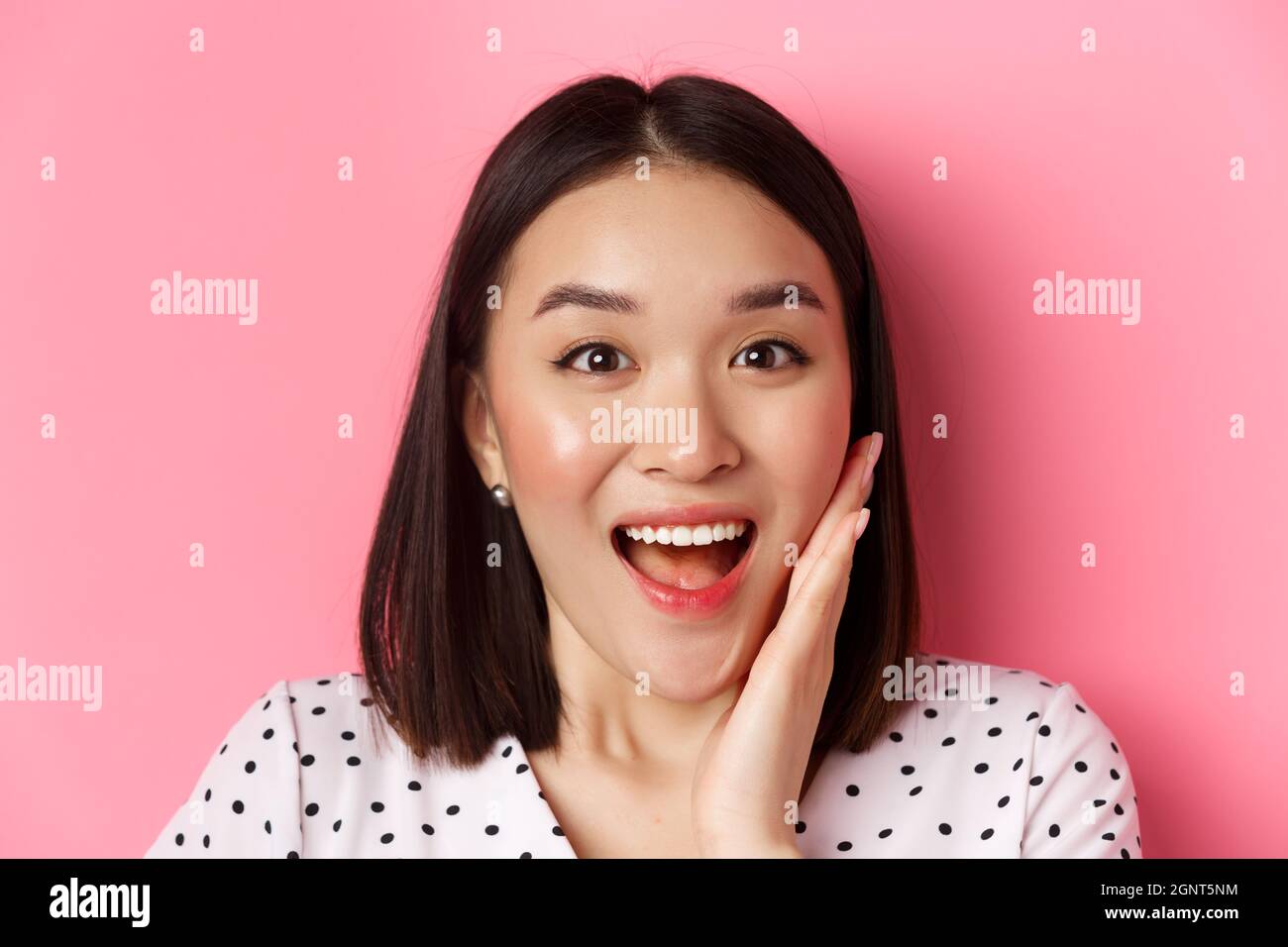 Beauty and lifestyle concept. Close-up of surprised and happy asian ...