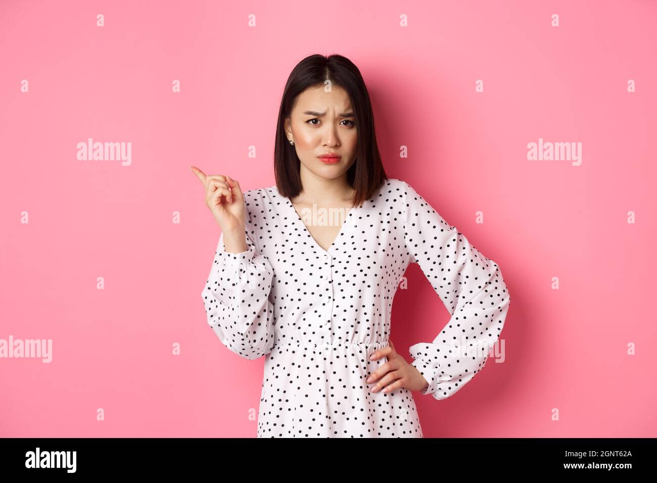 Disappointed asian girlfriend complaining, staring at camera and ...