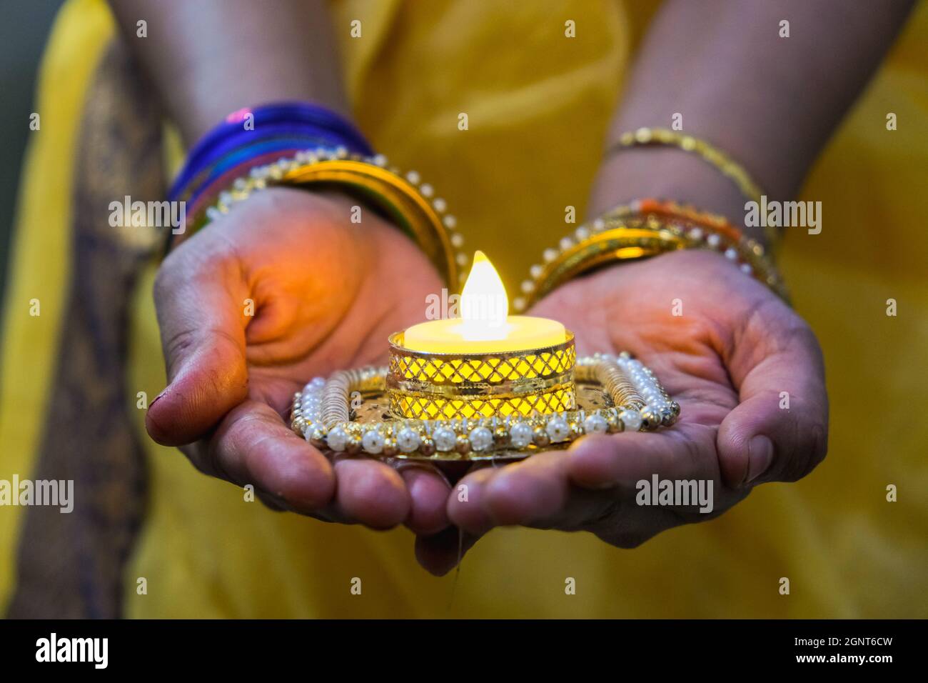 Lady holding diya hi-res stock photography and images - Alamy