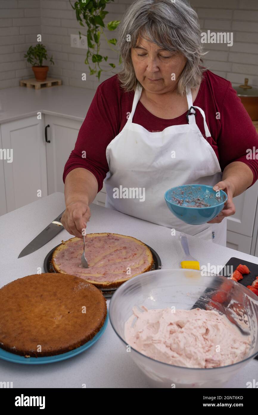 older woman making a cake Stock Photo - Alamy