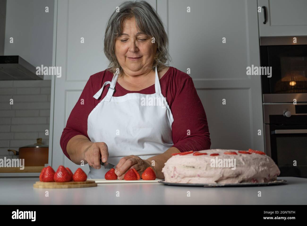 older woman making a cake Stock Photo - Alamy