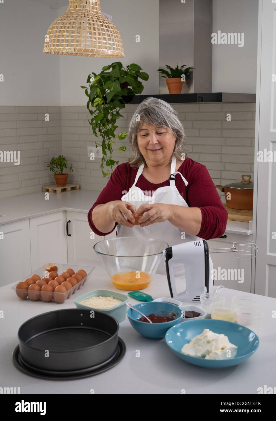older woman making a cake Stock Photo - Alamy