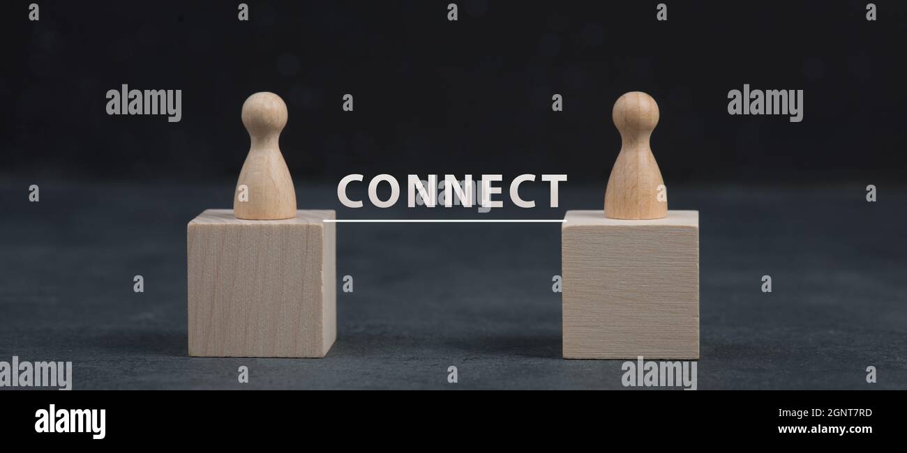 Two wooden persons connect to eachother Stock Photo - Alamy