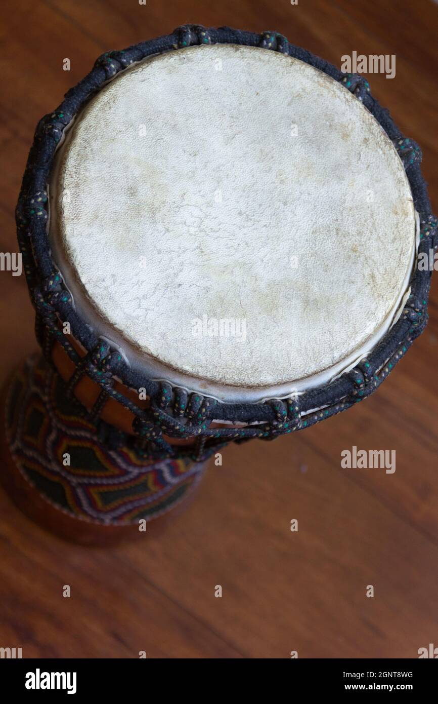 Top of djembe music instrument on brown wooden floor Stock Photo - Alamy