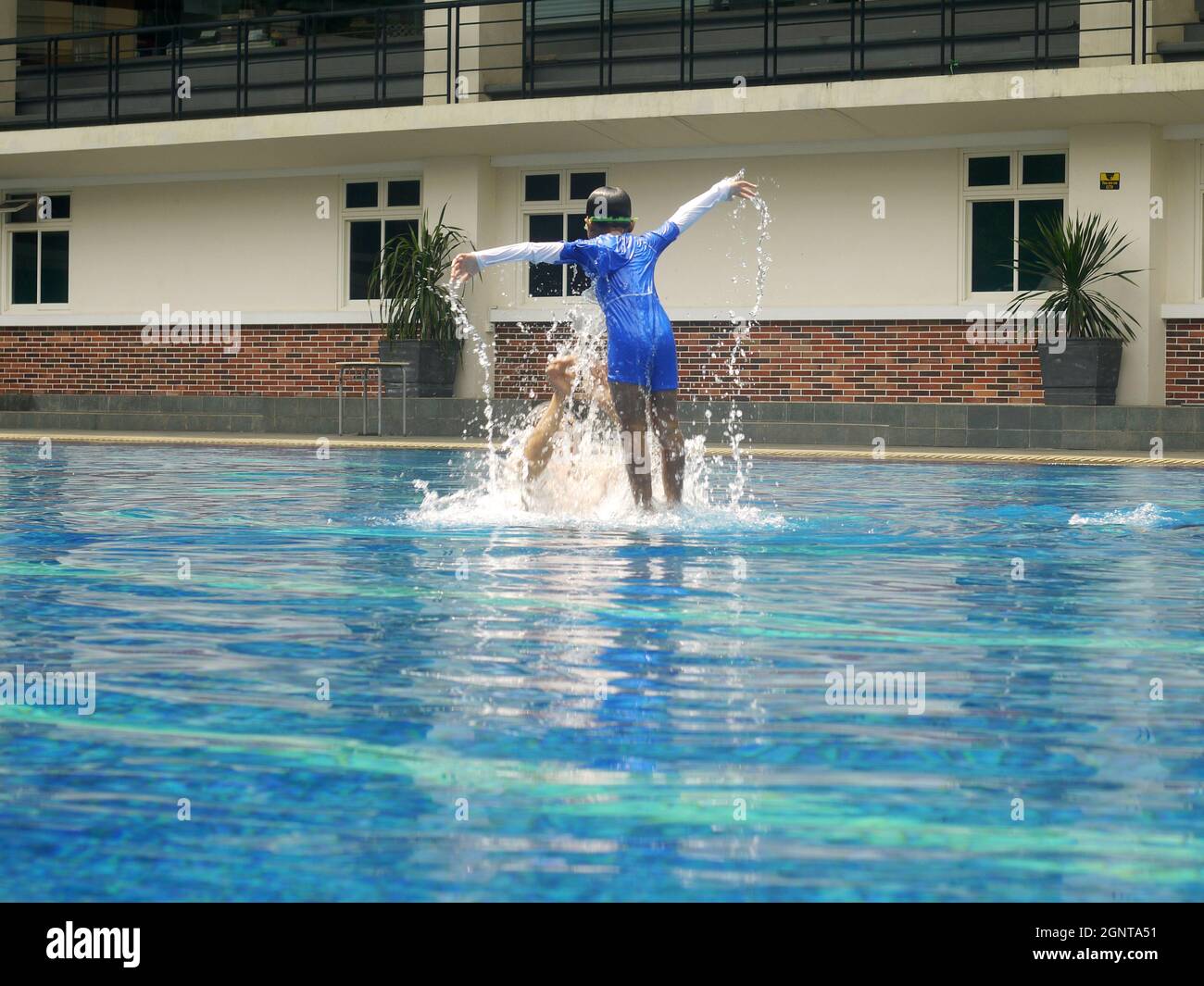 Little kid jumping swimming pool hi-res stock photography and images ...