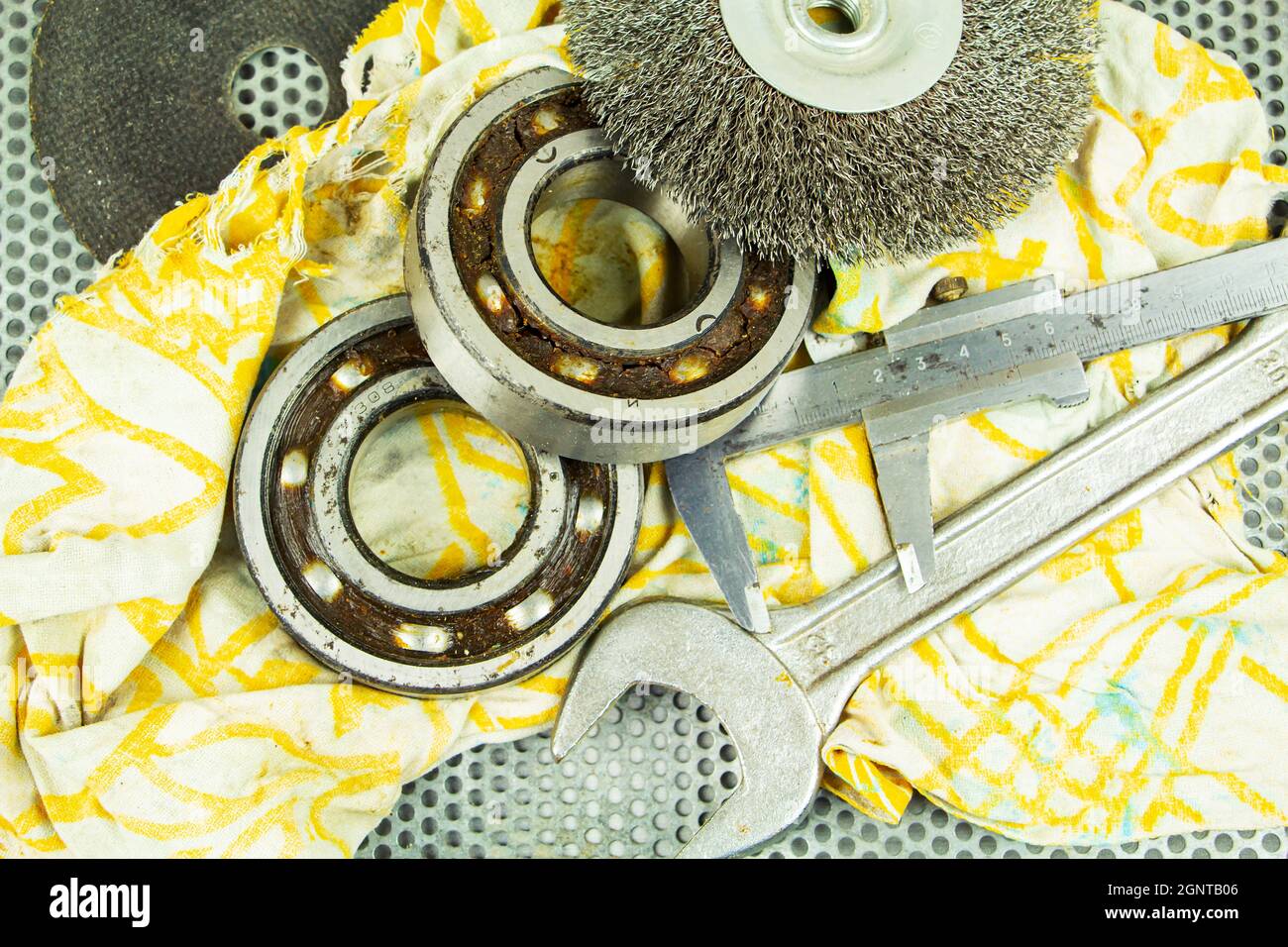 Metalworking tools, steel parts, a wrench, on the background of a metal ...