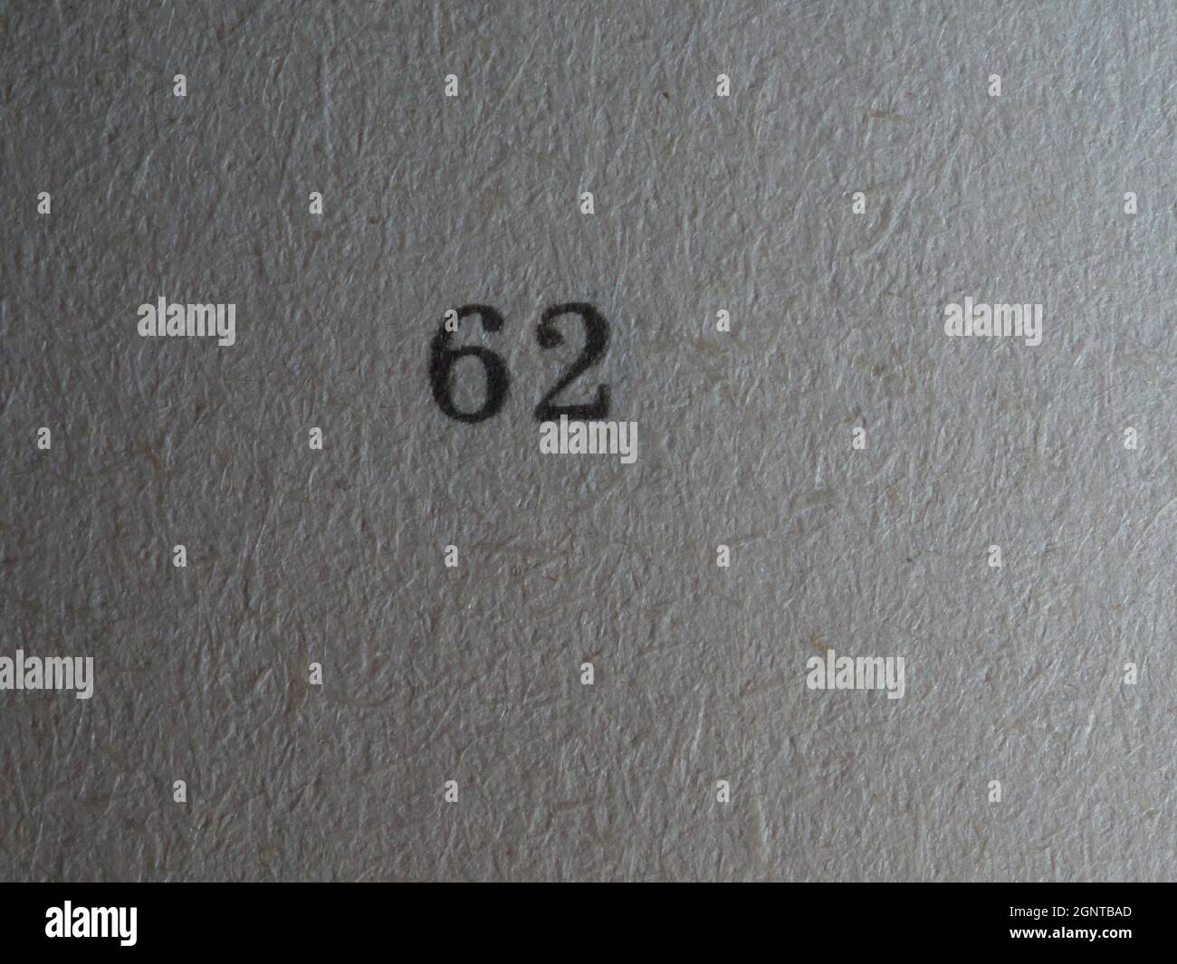 The number 62 printed on a piece of paper. Paper texture Stock Photo ...