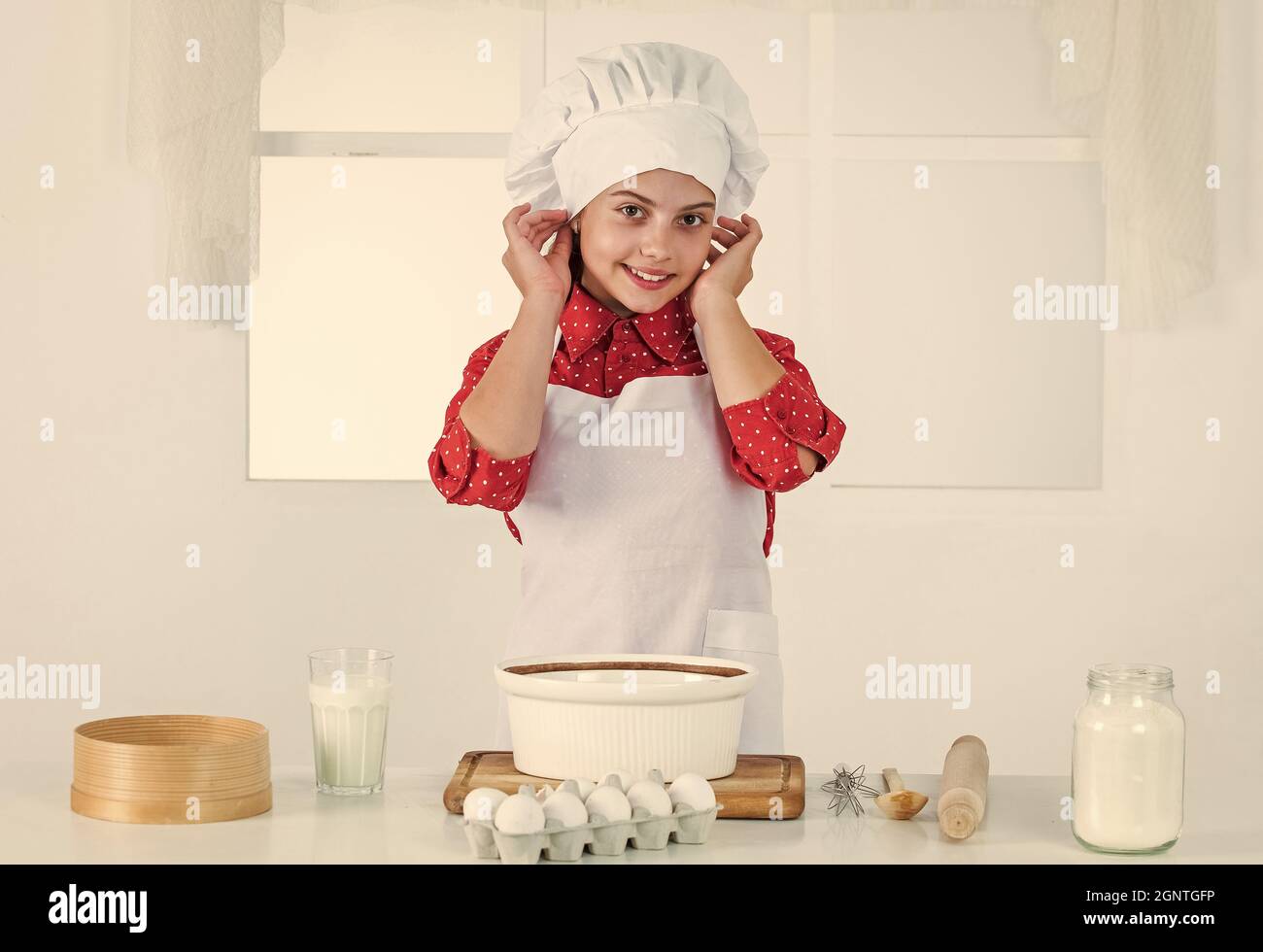 cheerful child girl cooking home pastry, dough Stock Photo - Alamy