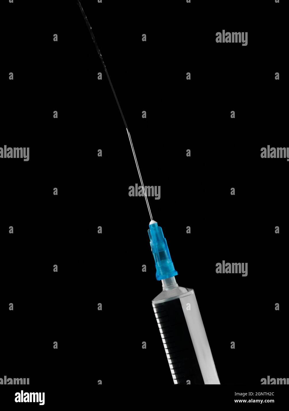 syringe with a needle filled with liquid, on a black background ...