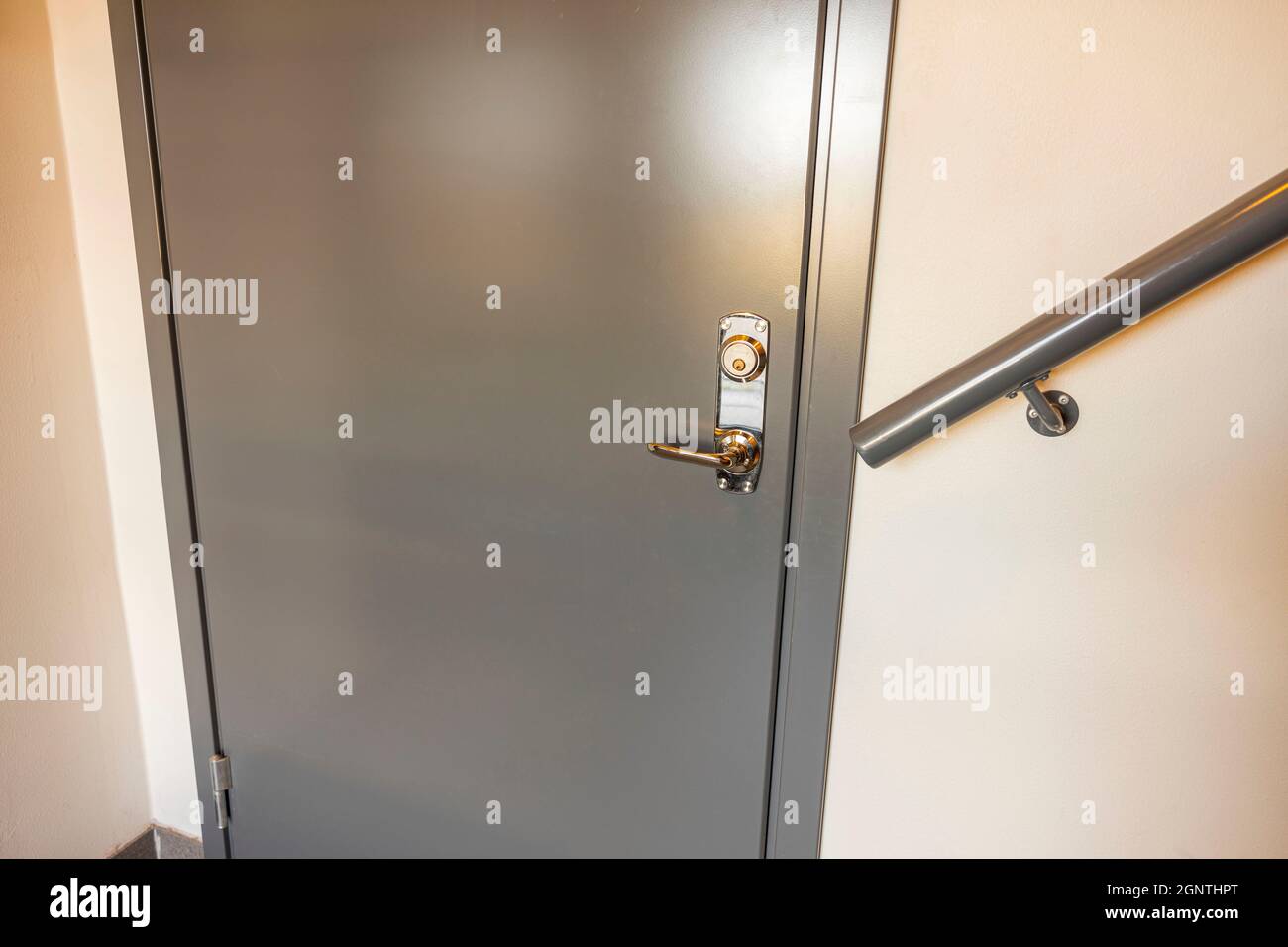 Close up view of a closed super-heavy door when entering a staircase ...