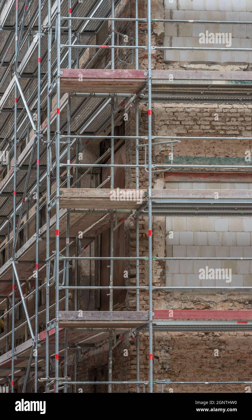 Scaffolding on the facade of a former factory Stock Photo - Alamy