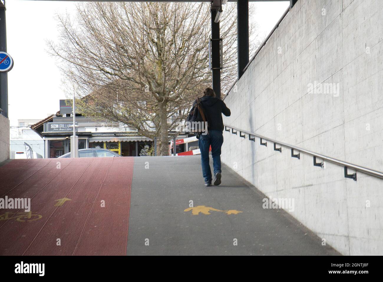 Rear view of a man walking out of the underground walkway Stock Photo ...