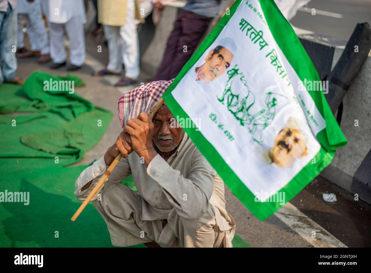 Ghaziabad, India. 27th Sep, 2021. A farmer holds a Bhartiya Kisan Union ...
