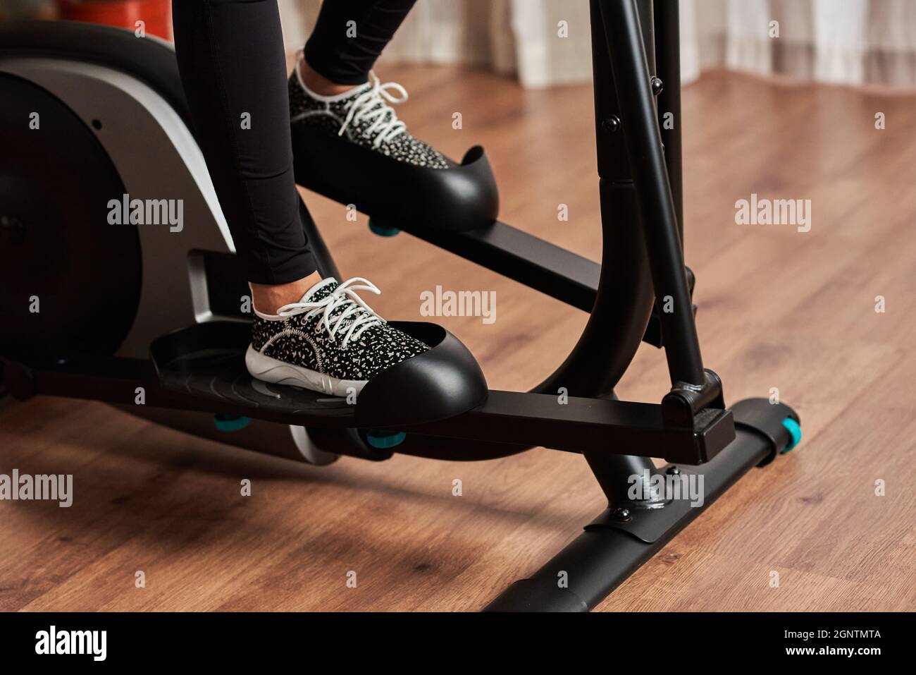 Woman training on elliptical machine hi-res stock photography and ...