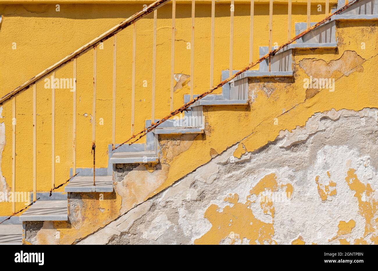 Yellow painted flight of stairs or steps in a shabby chic weather ...