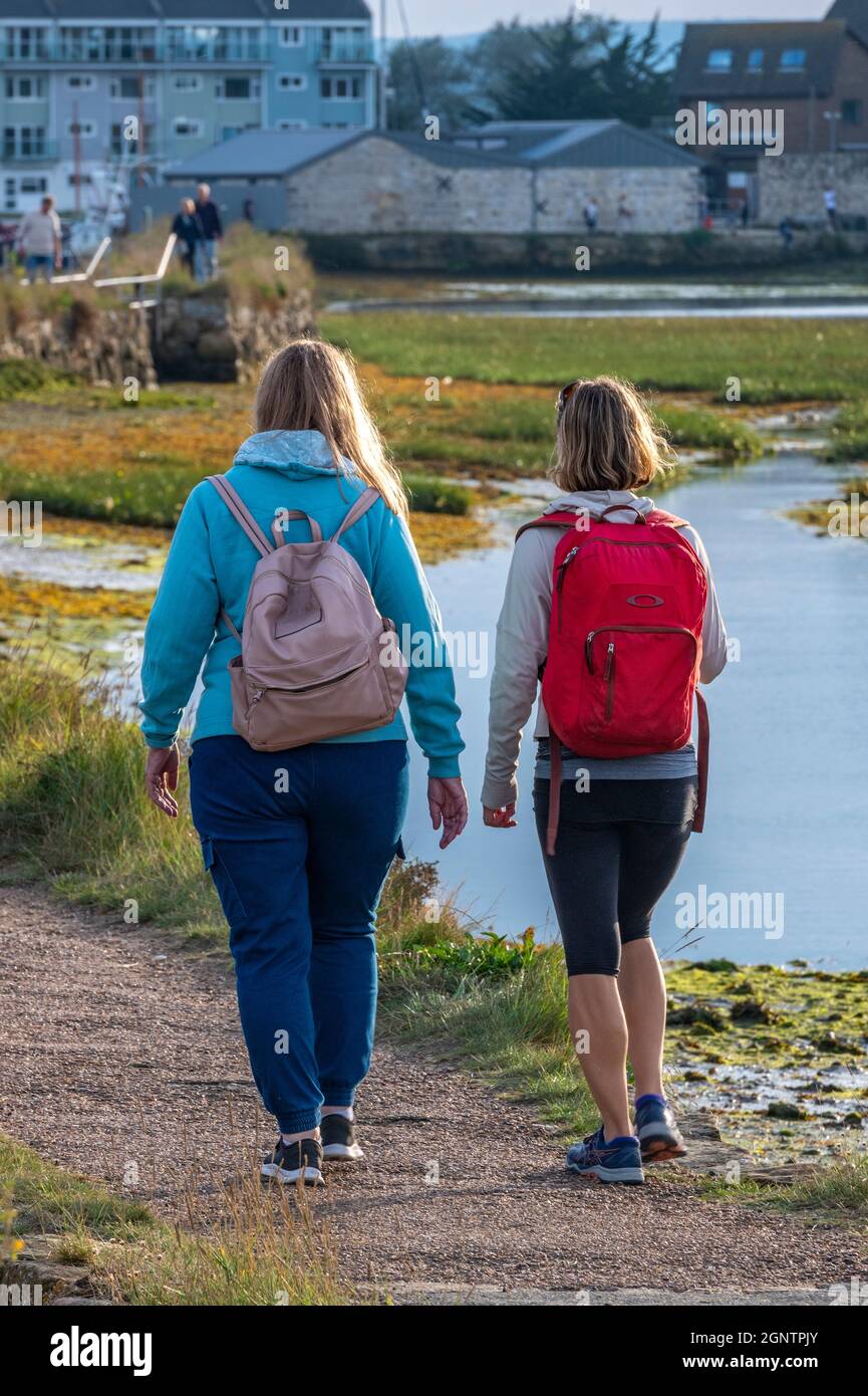 two middle aged women walking together on the isle of wight in the ...
