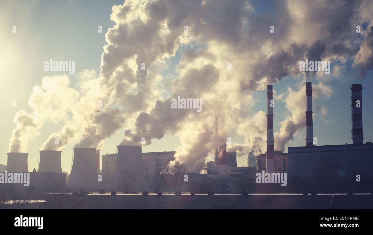 Smoke from industrial pipes on a clear sunny day, smog from factory ...