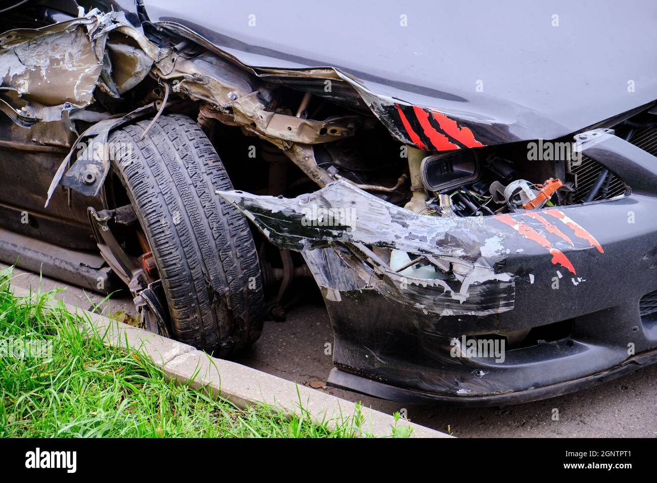 A high speed racing car crashed in an accident, a bumper and a wheel ...