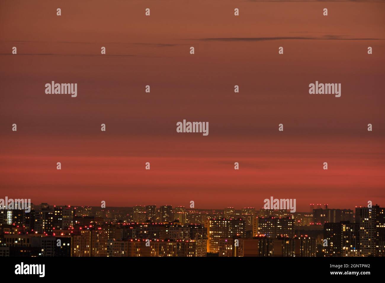 Night city lights at dusk sunset, red sky over houses Stock Photo - Alamy