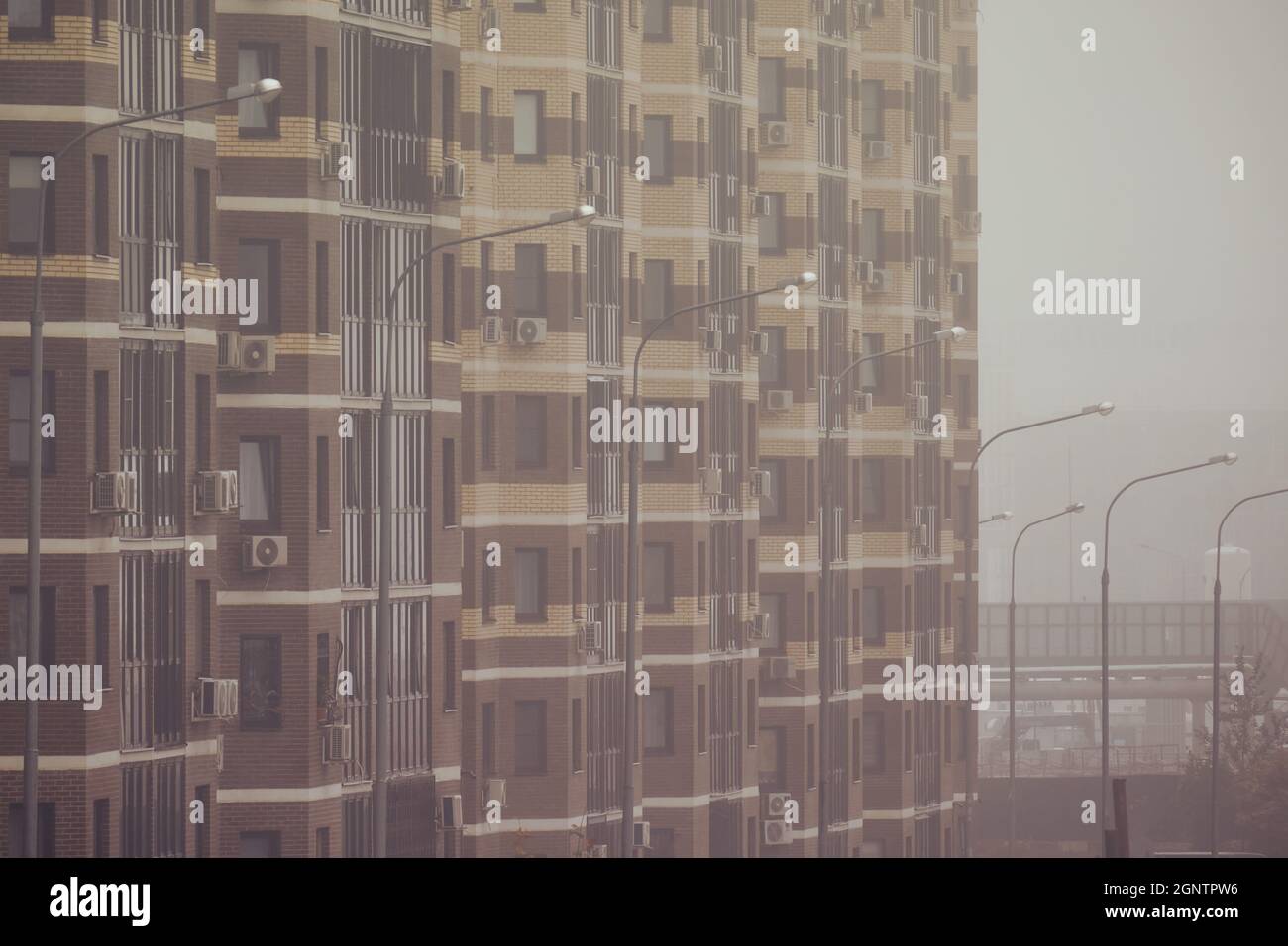Windows on the facades of high-rise apartment buildings, fog close-up ...