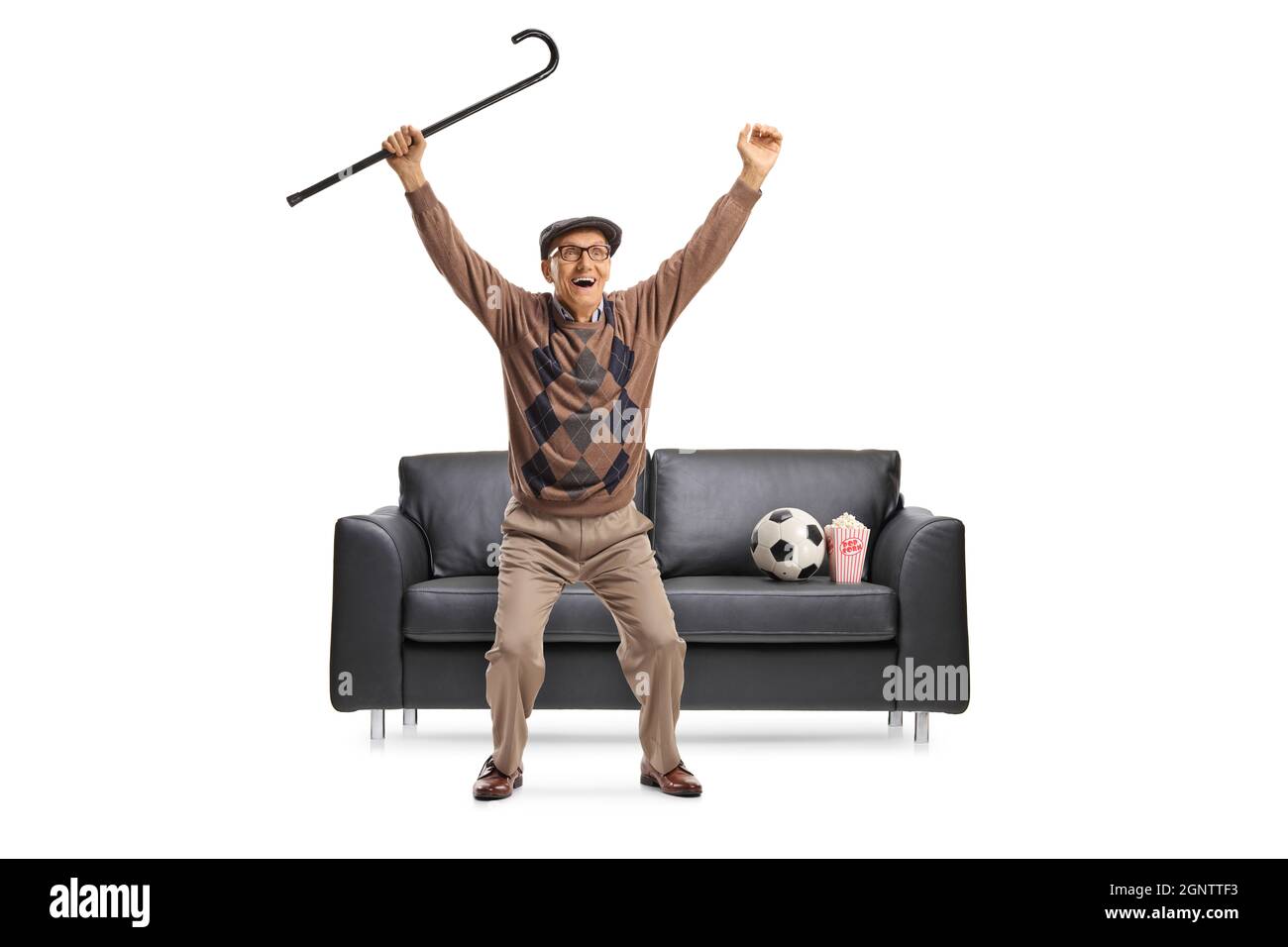 Senior man jumping from a sofa and cheering for a football team ...