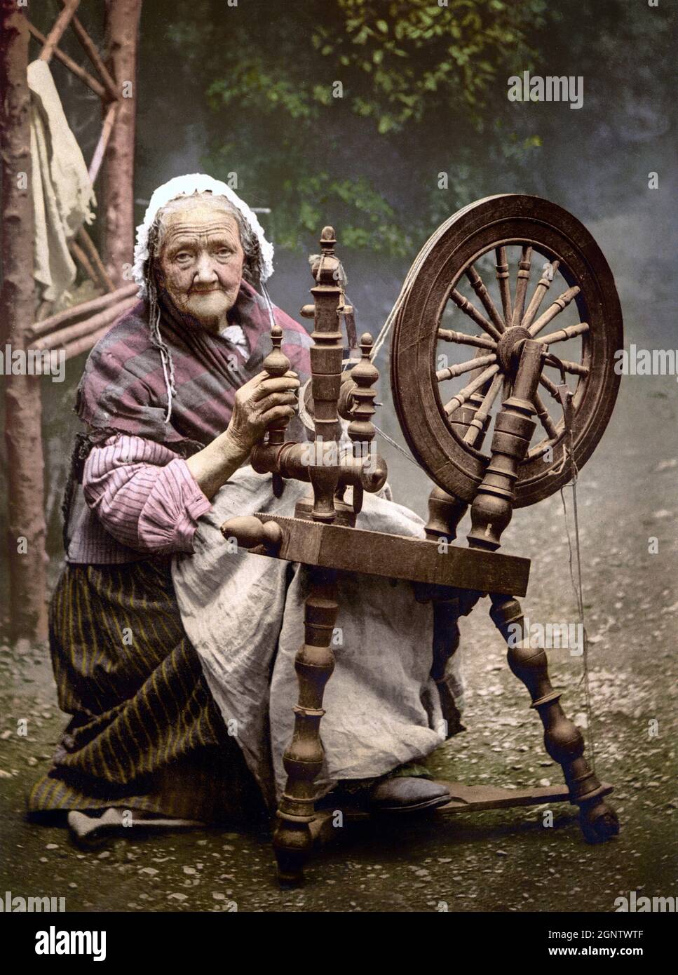 A 19th century, quintessential Photochrom of an old woman spinning yarn ...