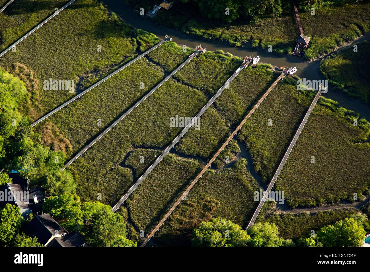 Aerial view of long docks crossing the salt marsh and coastal estuaries ...