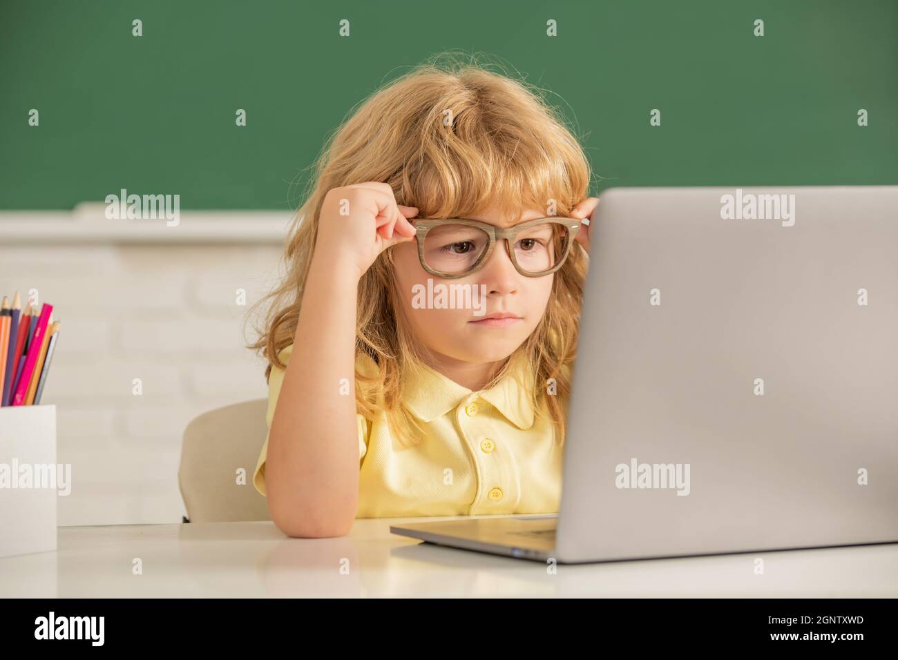 smart nerd kid in glasses with laptop. september 1. e-learning. child ...