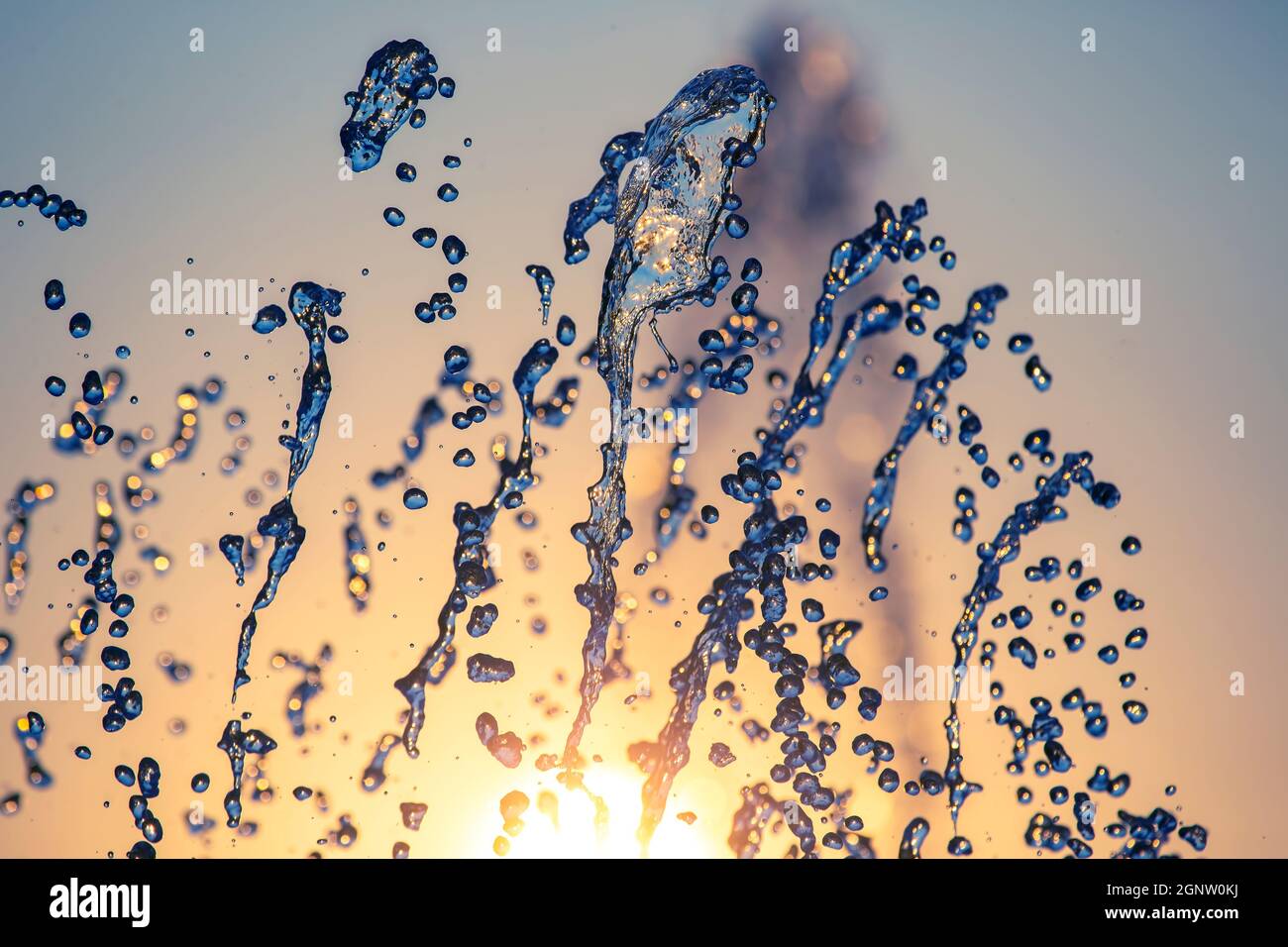 silhouettes of drops falling water fountain in the setting sun Stock ...