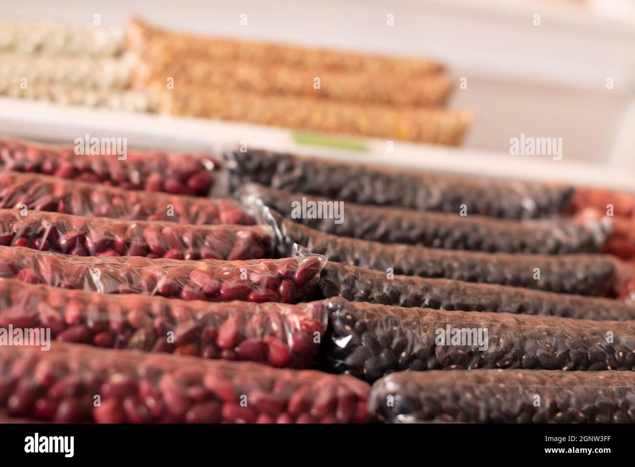 Red and black beans stacked in bags. Transparent bags. Dry bean store ...