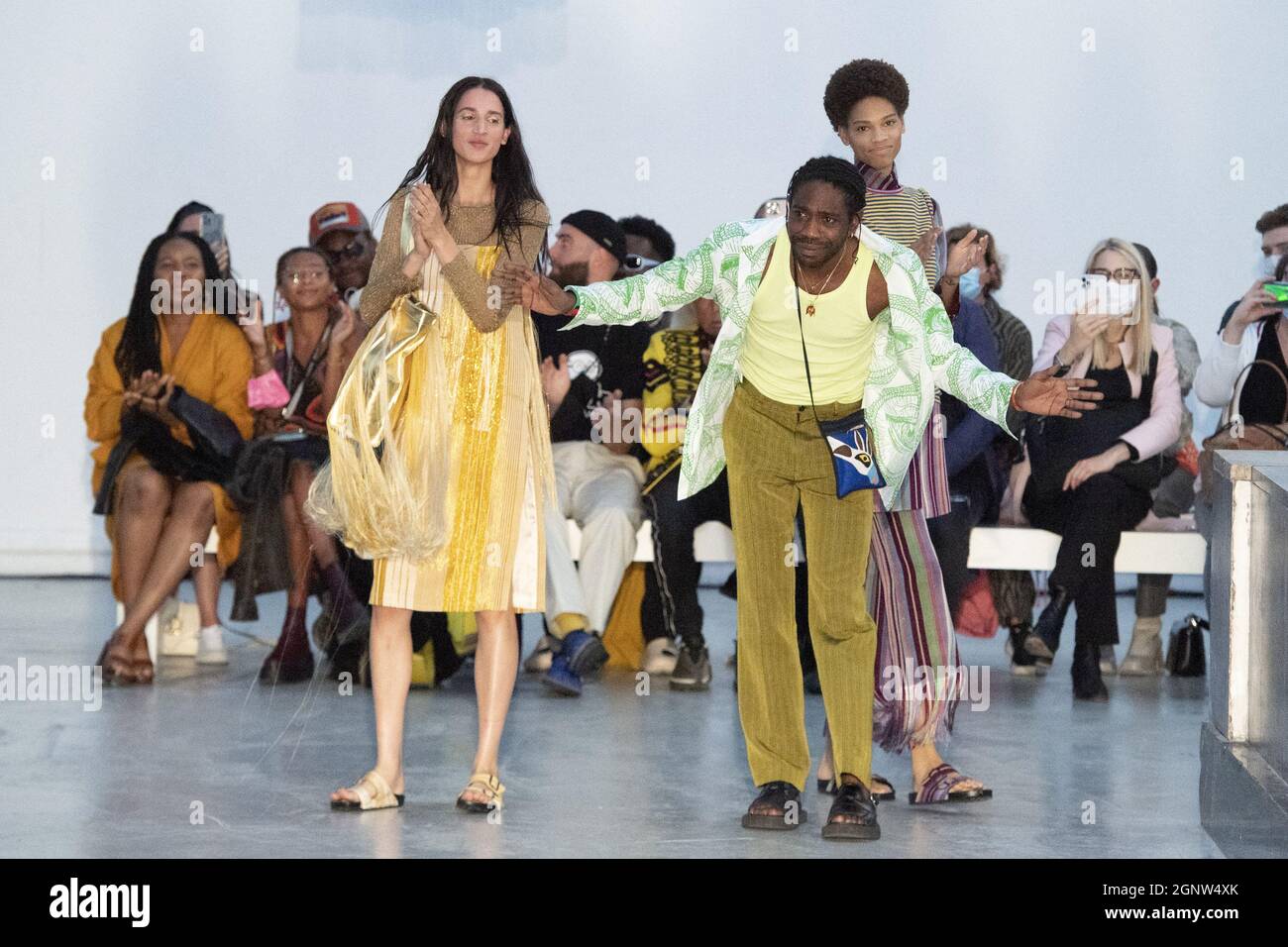 Designer Kenneth Ize makes an appearance on the runway during the ...
