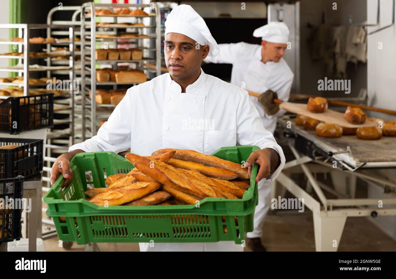 Male baker with box of bread at bakery Stock Photo - Alamy