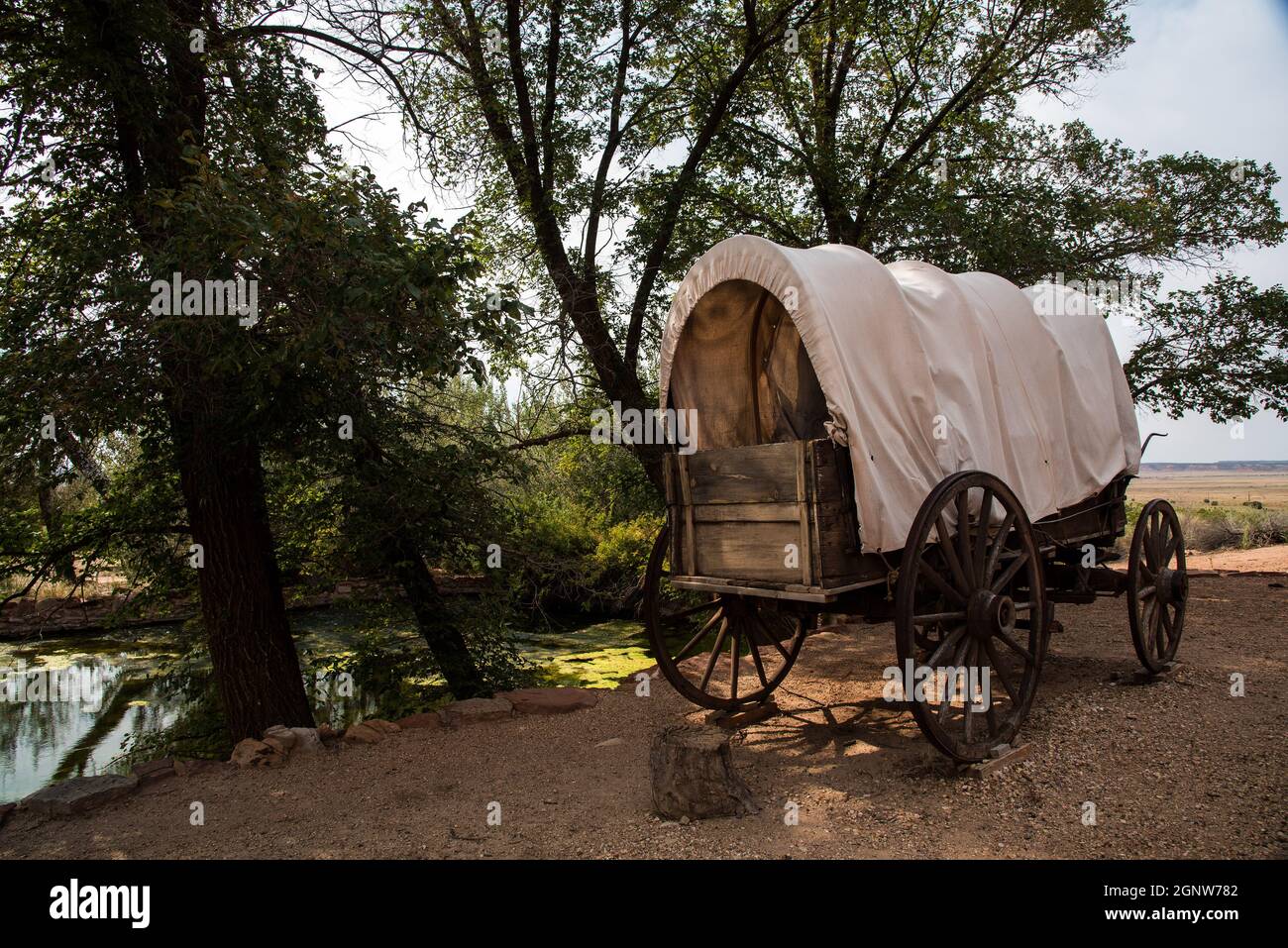 Covered wagon on a hill near a natural spring. The wagon is ready to be ...