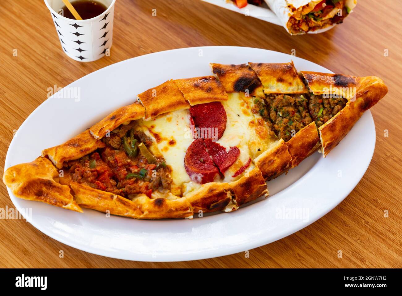 Pide, Turkish flat bread with mixed filling Stock Photo - Alamy