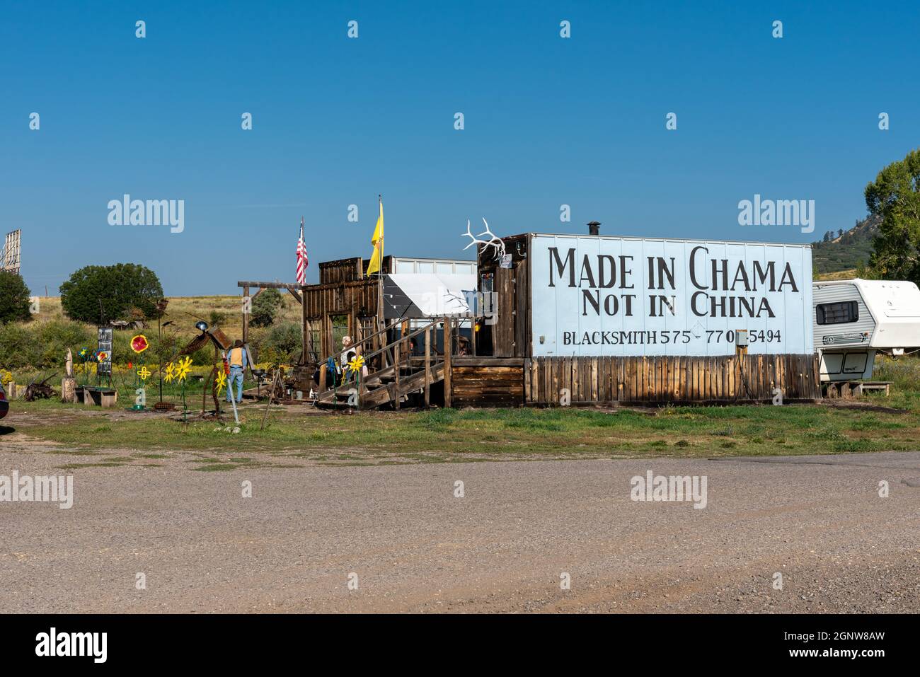 Blacksmith in Chama advertises on a large sign painted on side of a ...