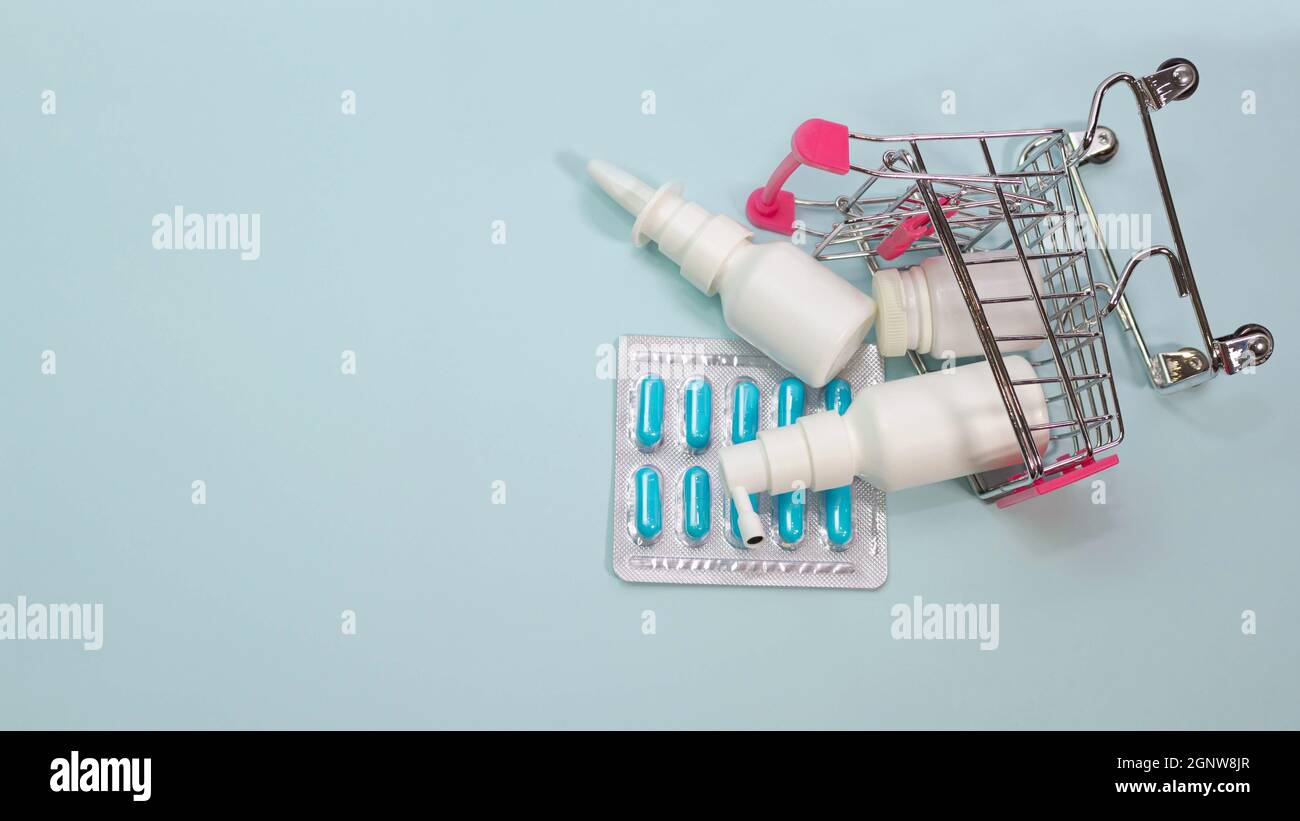 Health concept, pills in a trolley on a blue background, top view ...