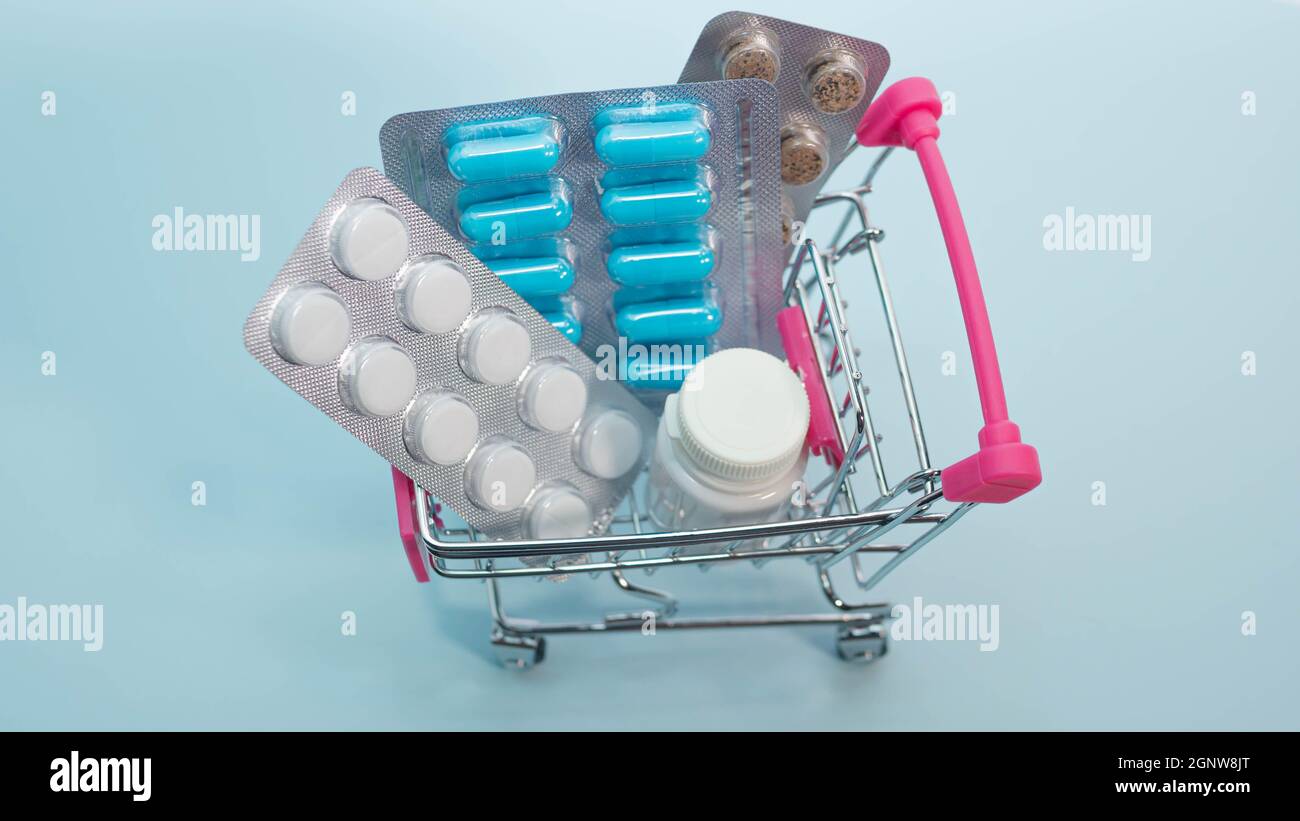 Health concept, pills in a trolley on a blue background, top view ...