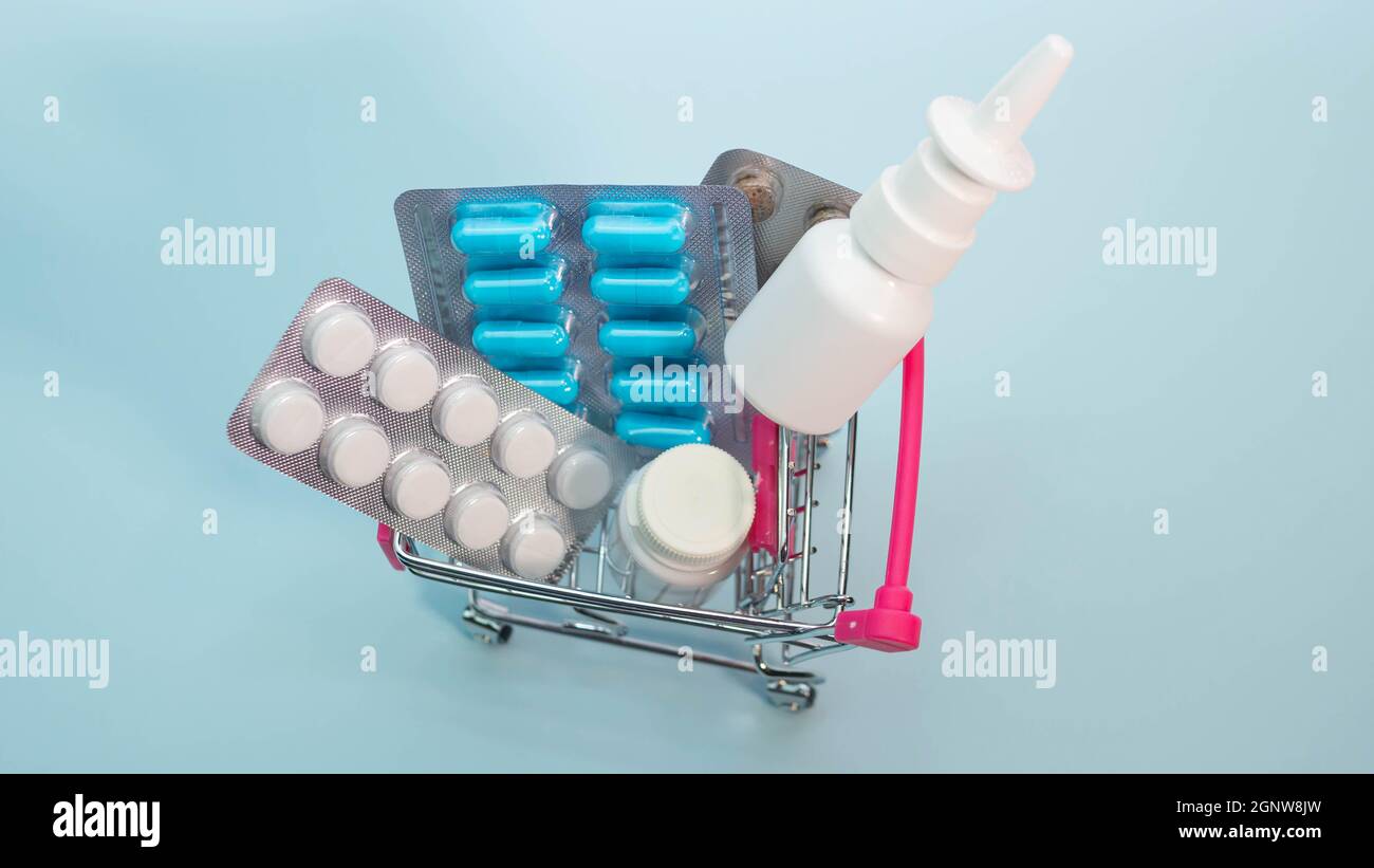 Health concept, pills in a trolley on a blue background, top view ...