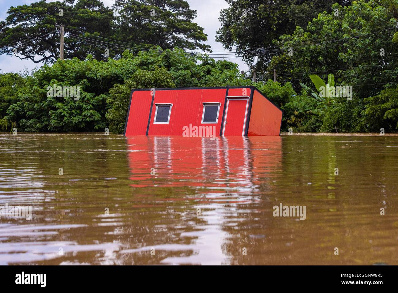 A container box house is seen floating after a heavy rainfall. Lopburi ...