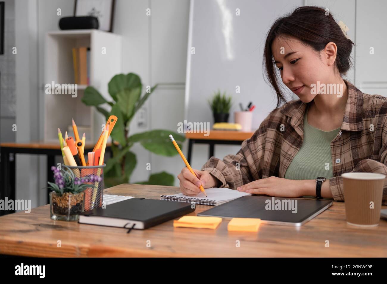 Cropped photo of woman writing making list taking notes in notepad ...