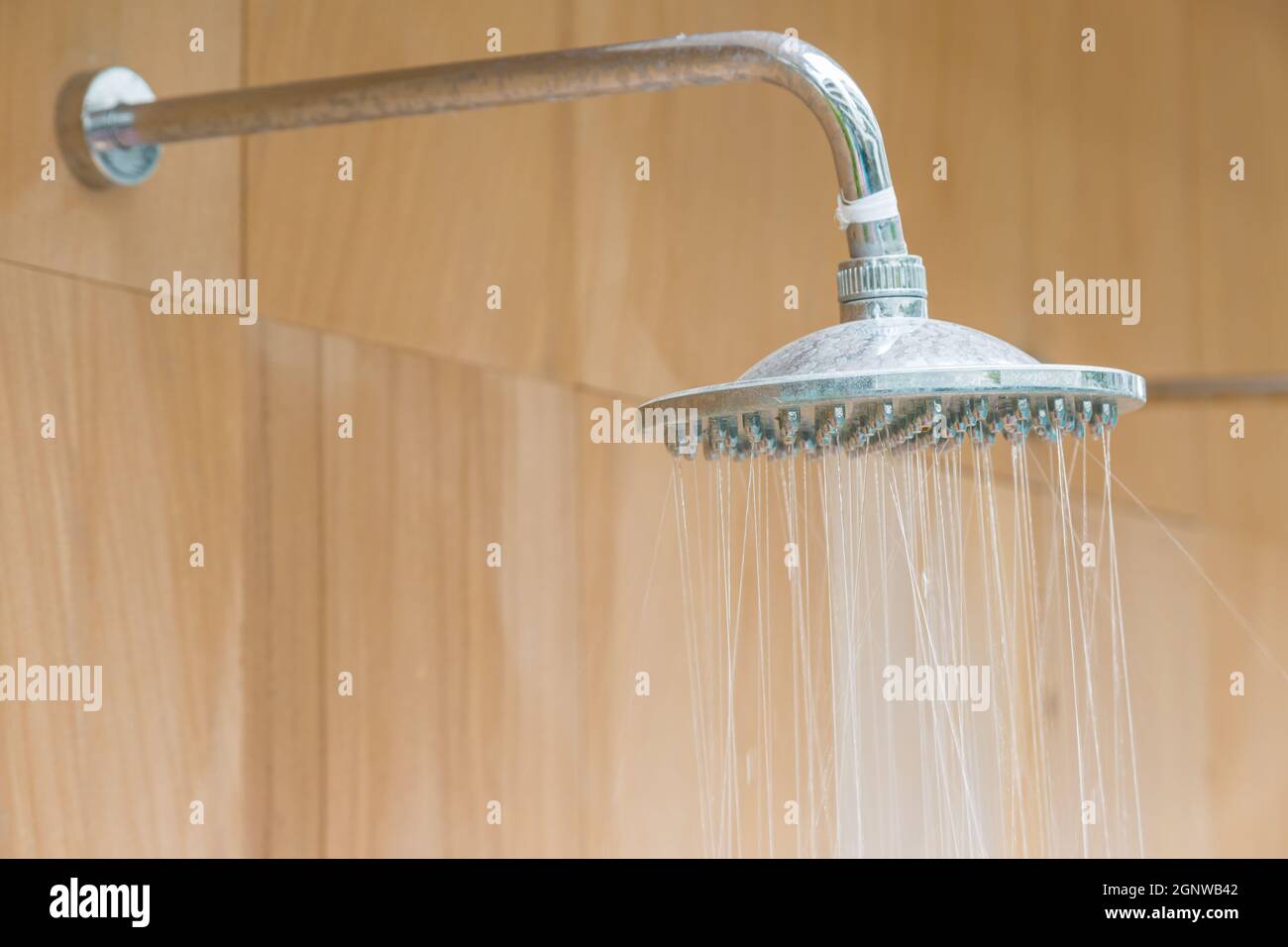 Outdoor shower sprinkler on brown wall background Stock Photo - Alamy