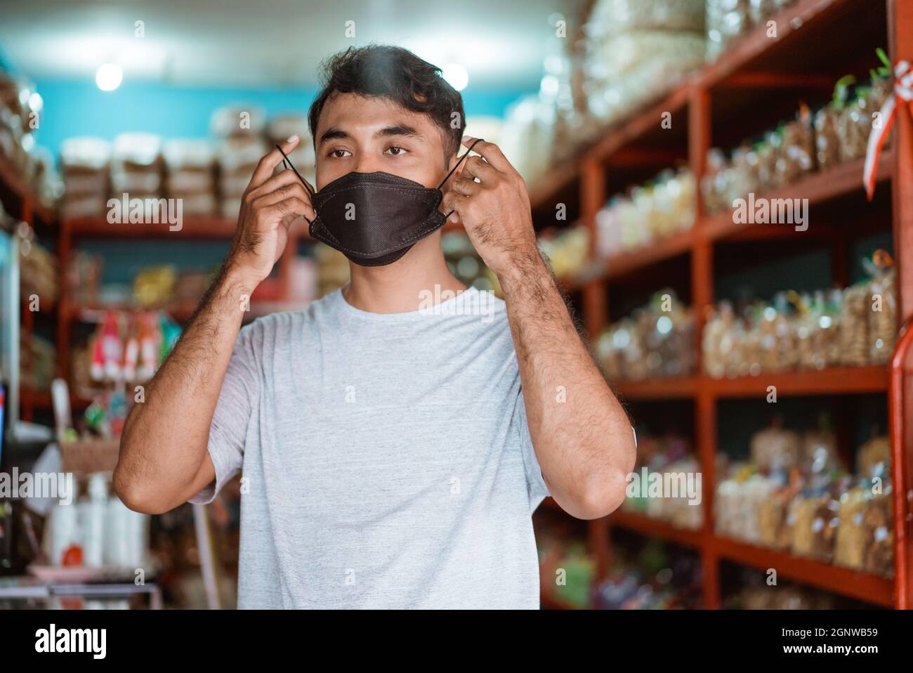 small business owner wearing face mask in front of his shop Stock Photo ...