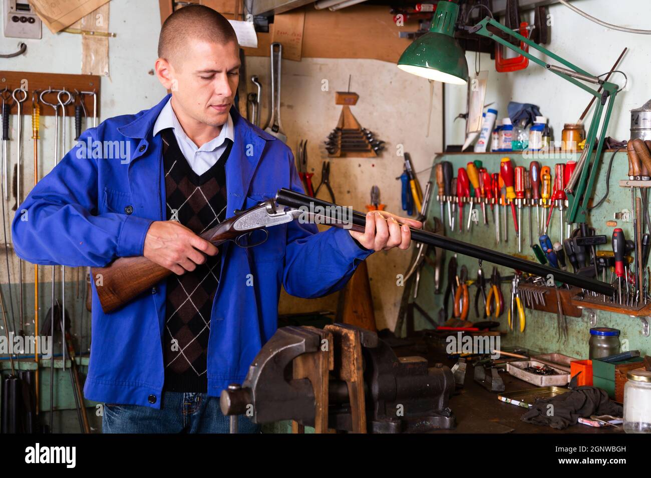 Gunsmith performing checkout of horizontal double rifle in weapons ...