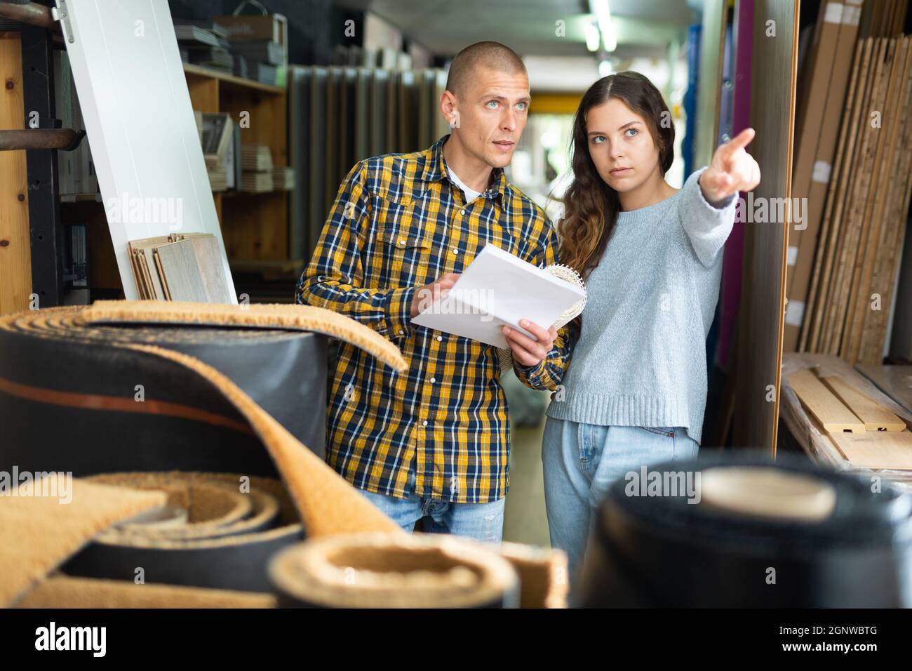 Customers shopping in building store and pointing to something Stock ...