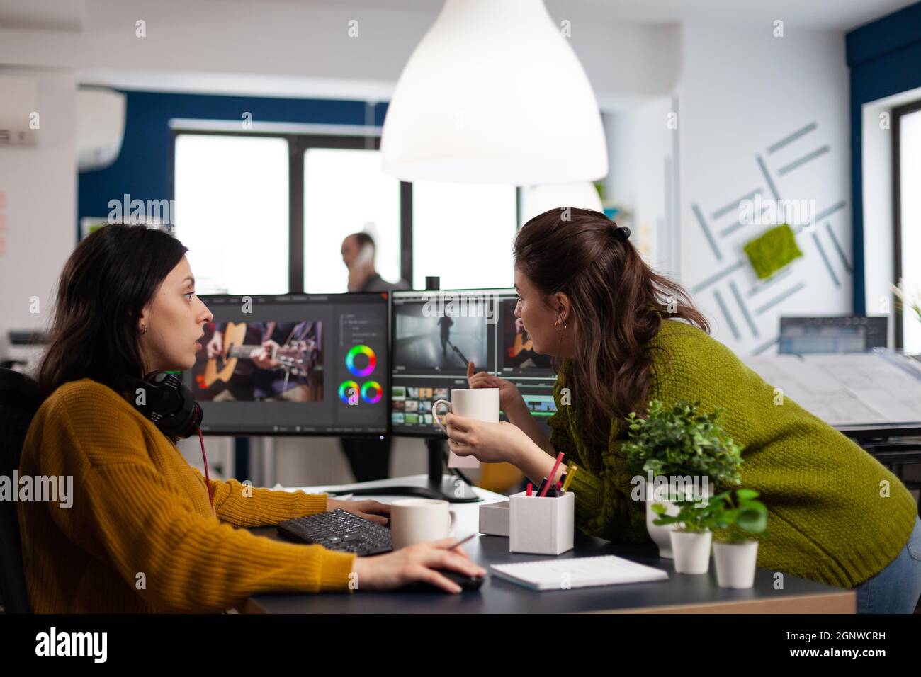 Happy coworkers talking about creative film montage looking at movie ...